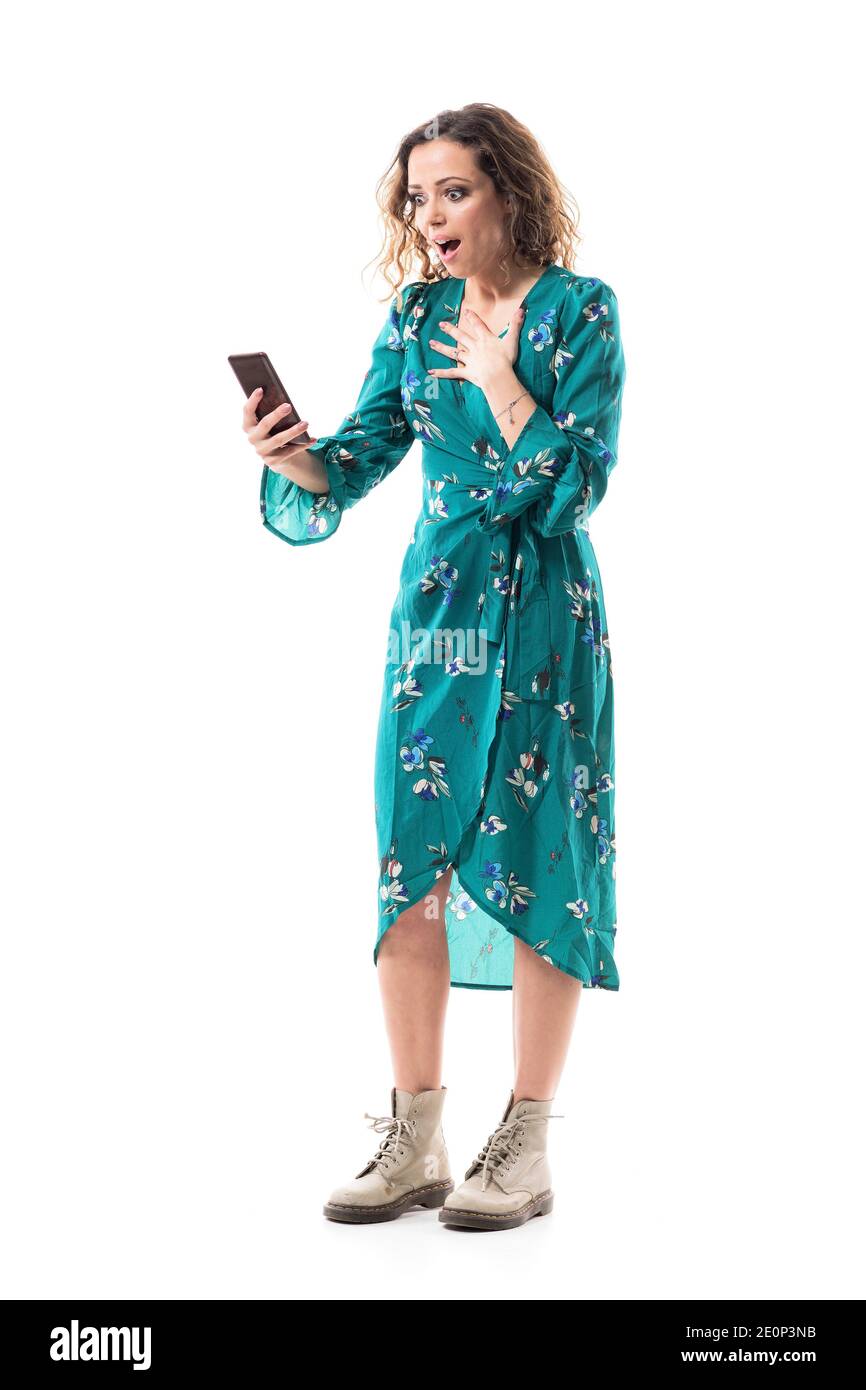 Excited amazed young wide-eyed pretty woman reaction while reading cell ...