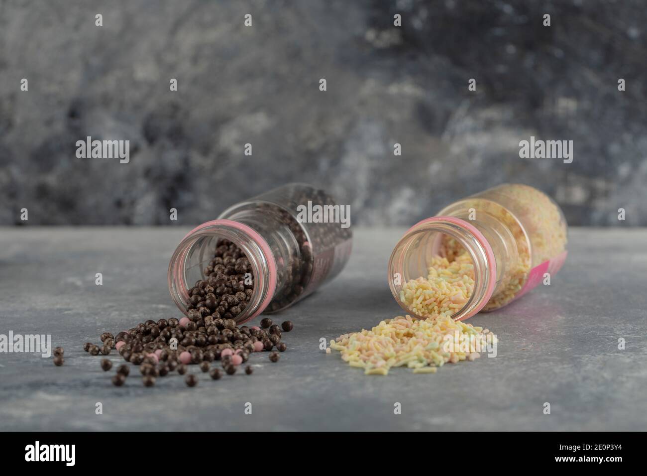 Two bottles of colorful sprinkle dotes on a marble background Stock ...