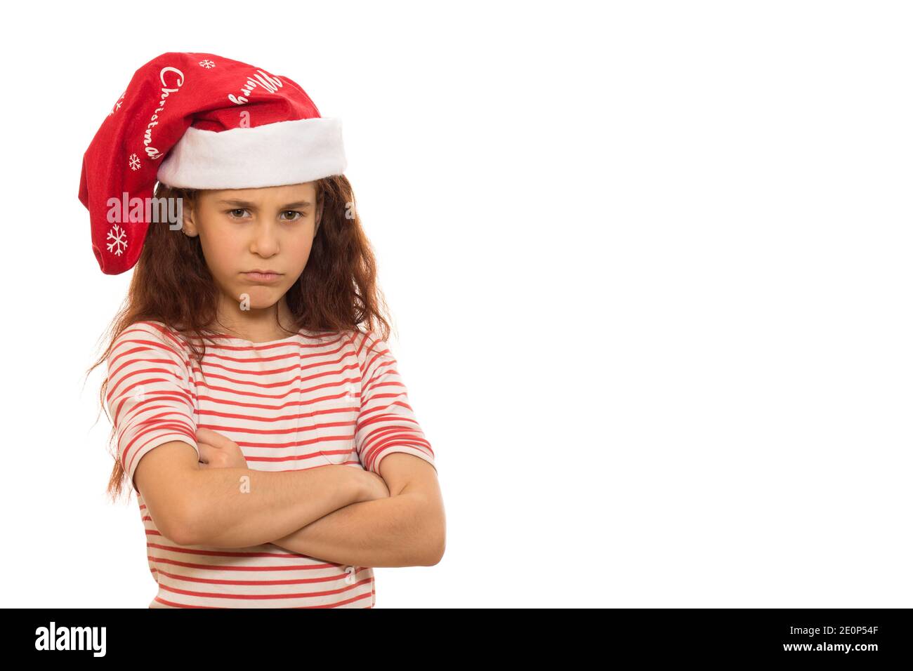 Cute pretty little girl wearing Santa Claus hat looking grumpy and ...