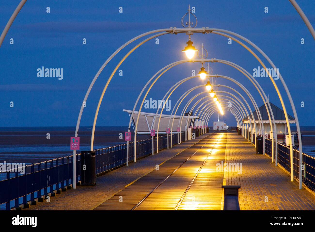 Southport pier, the longest iron pier in the UK illuminated at dawn in ...