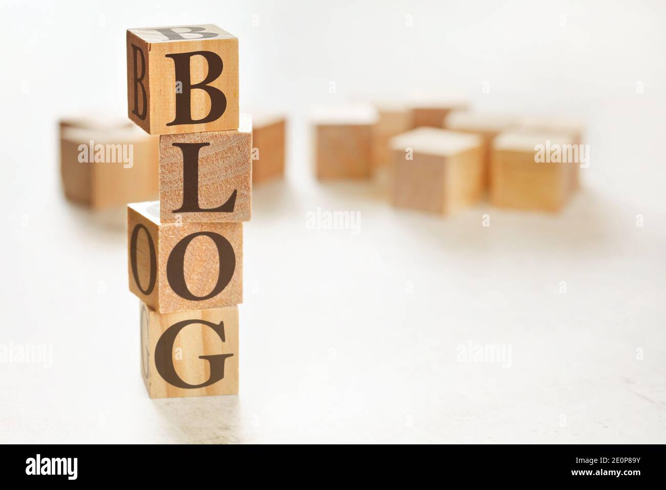 Four wooden cubes arranged in stack with word BLOG on them, space for ...