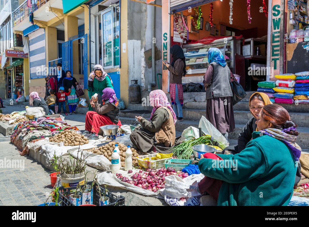 Women selling vegetables in the street market in the Leh City, Ladakh ...