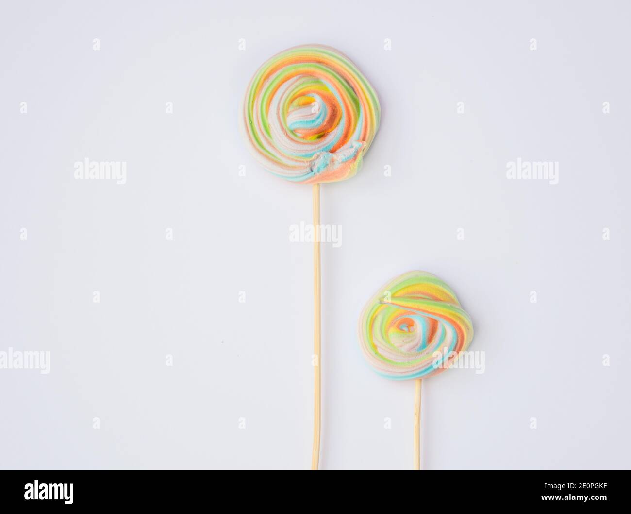 Colored bright meringues on a white background Stock Photo - Alamy