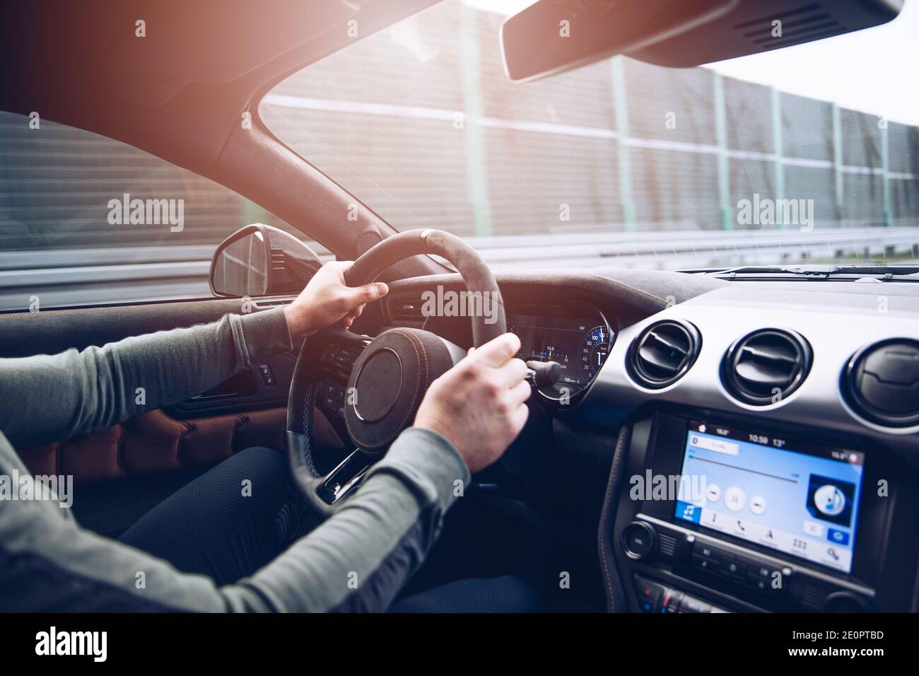 Mans hand on steering wheel hi-res stock photography and images - Alamy