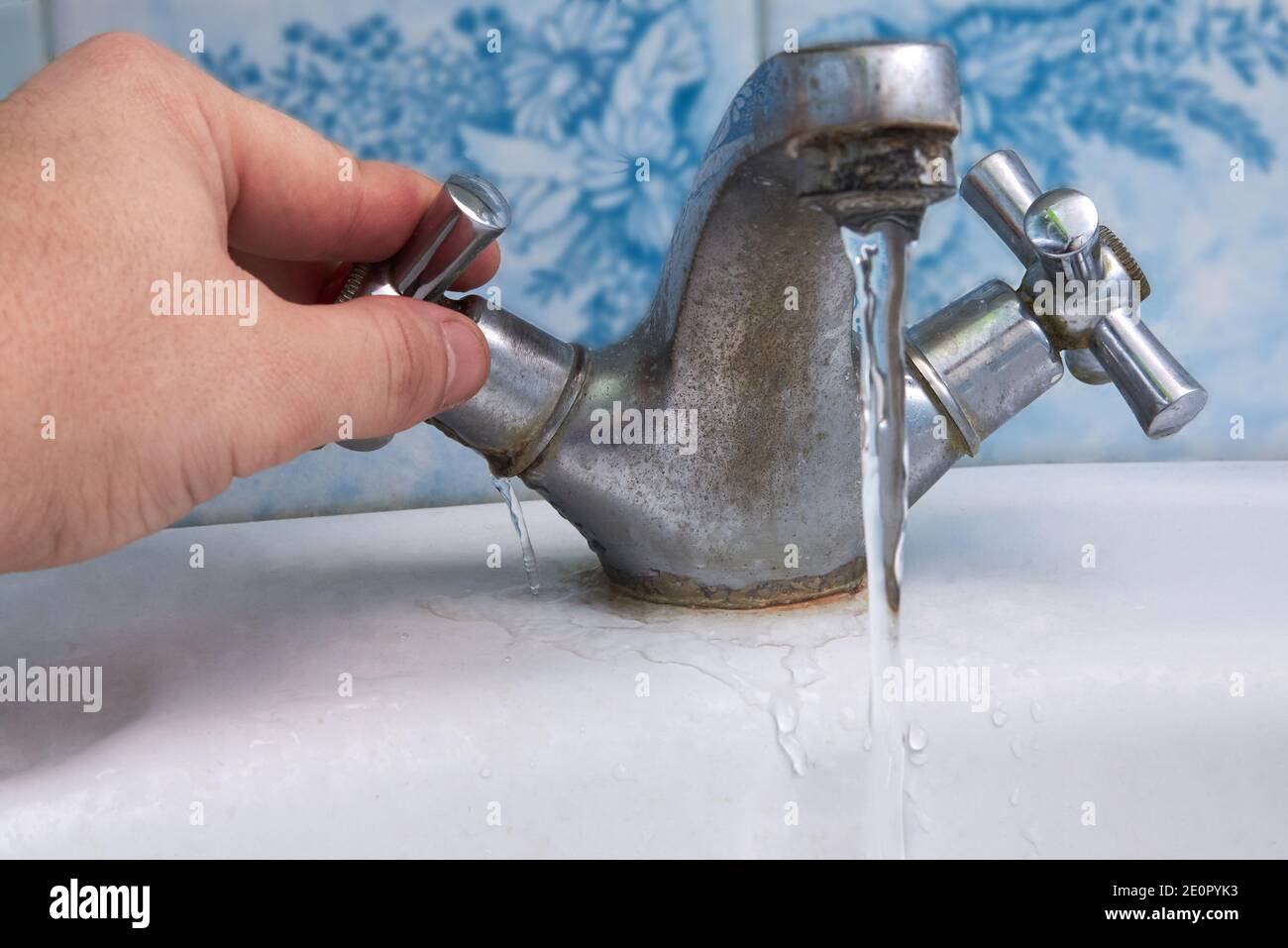 Water leaking from a rusty old faucet in the bathroom, home plumbing ...