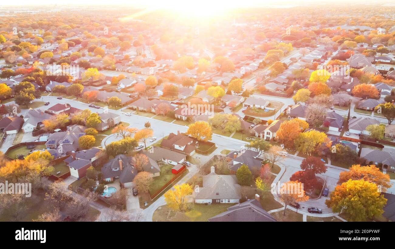 Suburban residential area with colorful fall foliage at sunset near ...