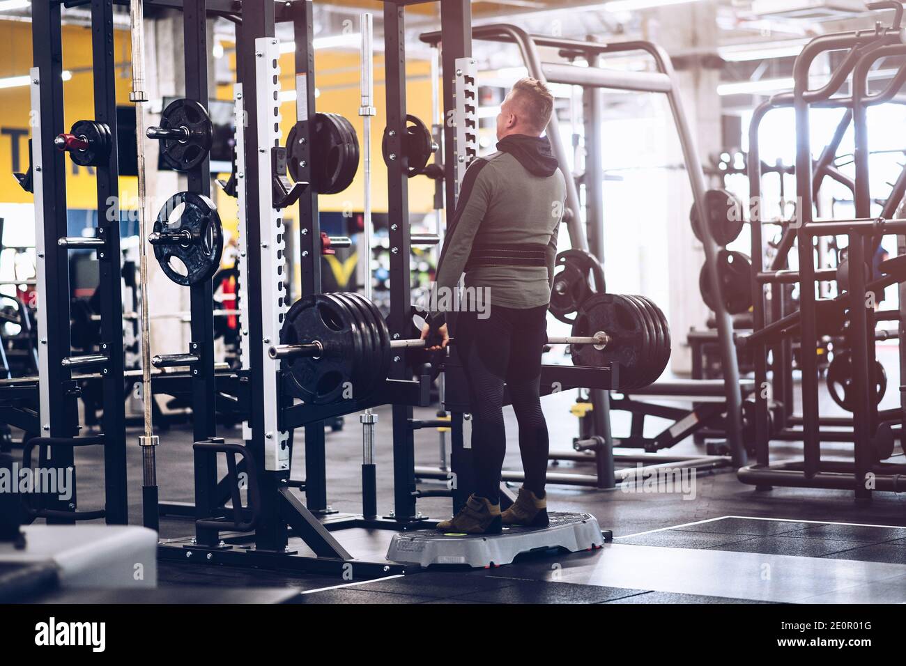 The man in the gym is lifting weights Stock Photo - Alamy