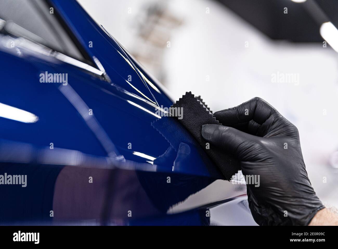 Car detailing studio worker applying ceramic coating on car Stock Photo ...