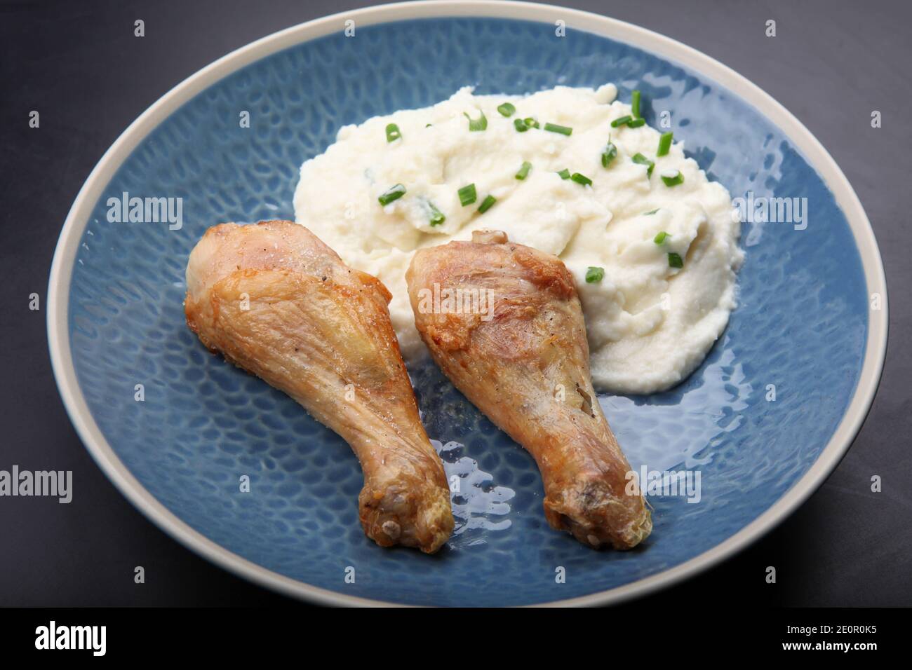Chicken legs and mashed cauliflower Stock Photo - Alamy
