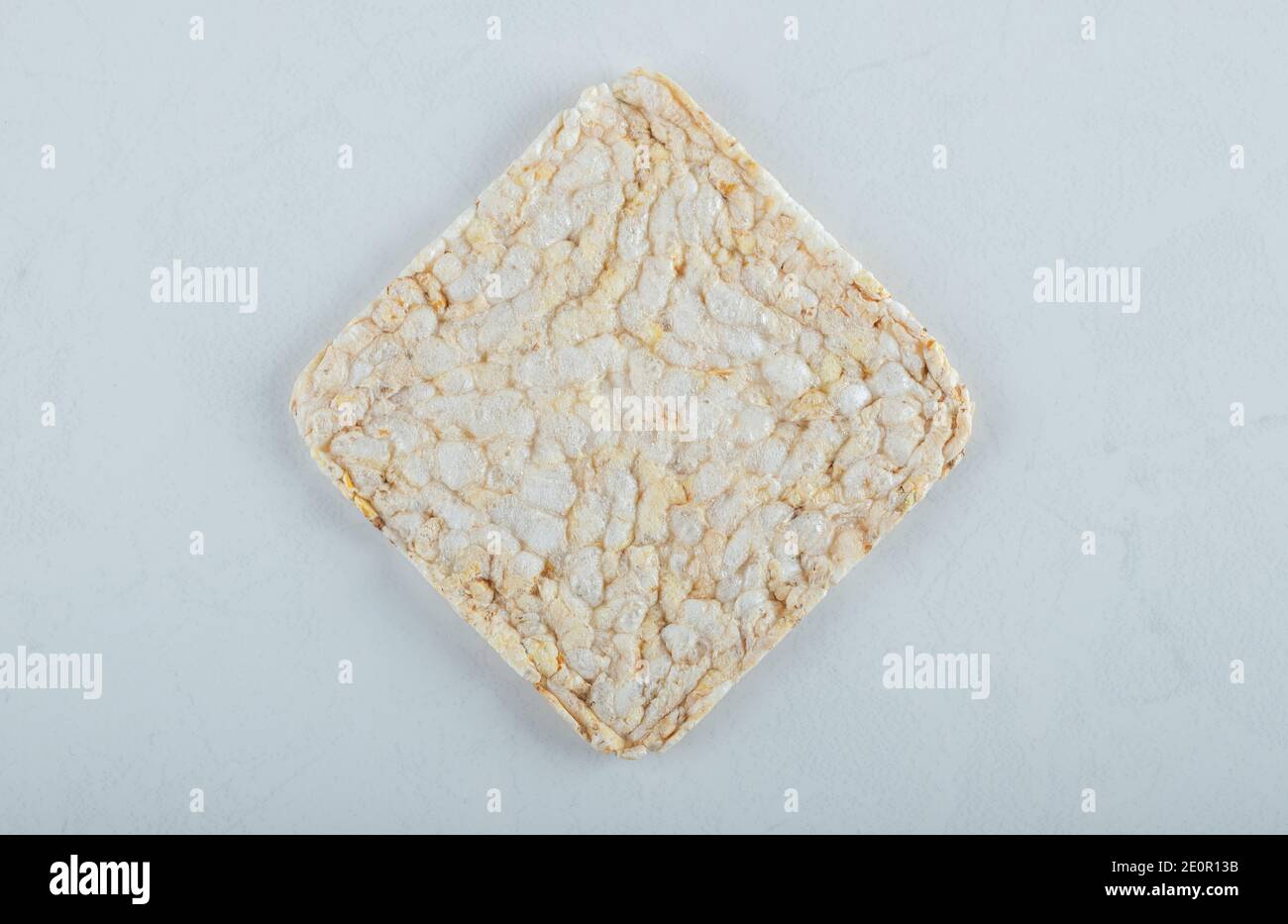 Single airy crispbread on white background Stock Photo - Alamy