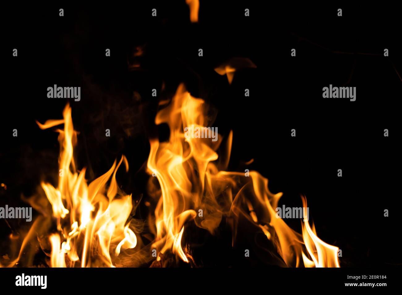 Fire flames on a black background. Abstract fiery texture. Realistic ...