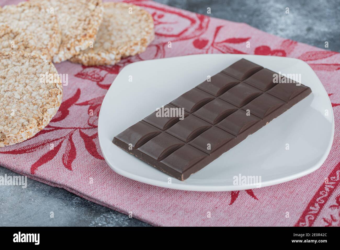 Crispy rice bread with bar of chocolate on a tablecloth Stock Photo - Alamy