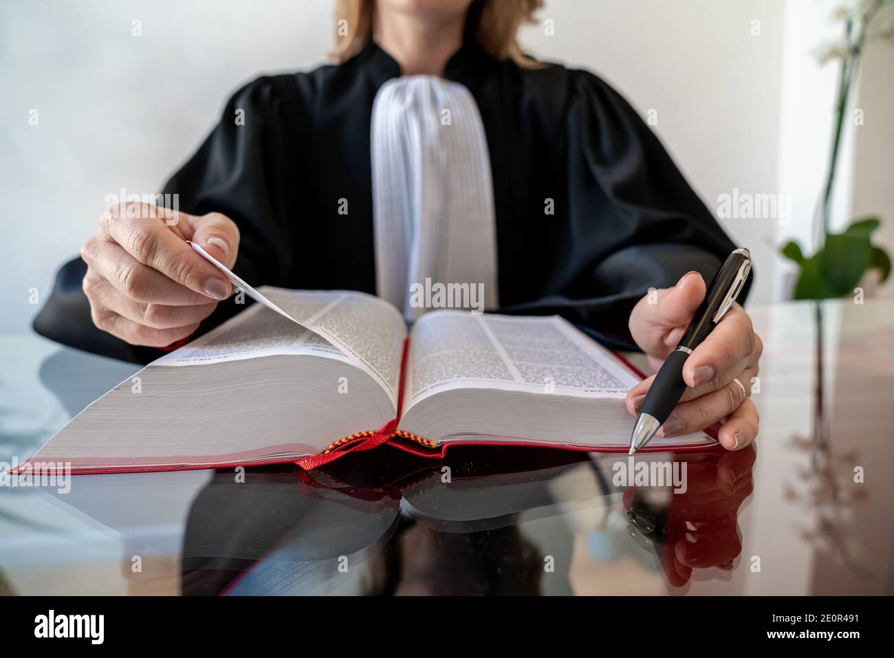Justice, lawyer woman holding and reading open red law book - French ...