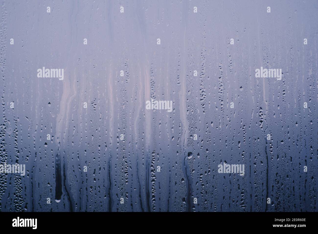 Drops of water on the sweaty glass with a blue tint. Background Stock ...