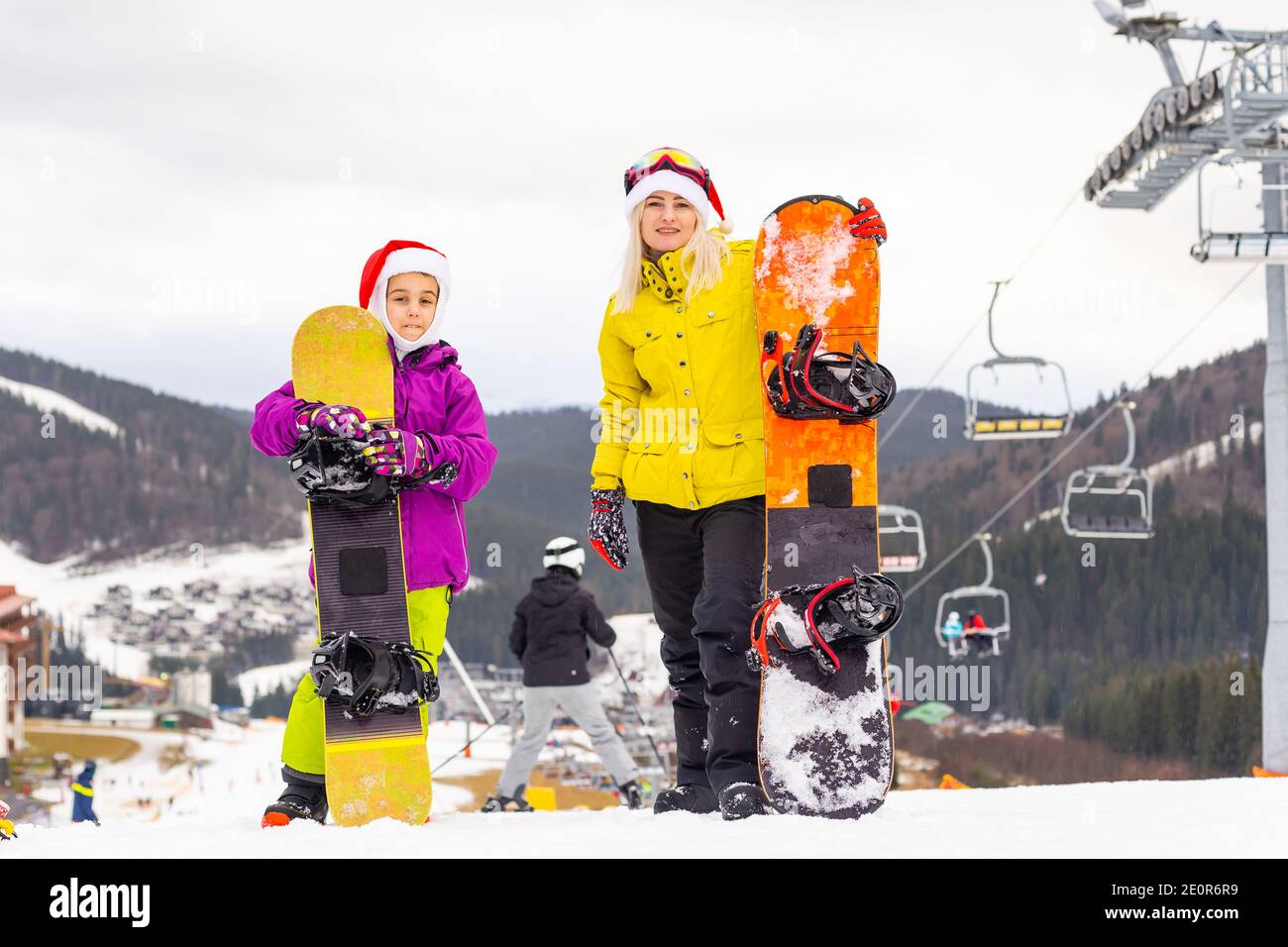 Winter time and skiing - family with ski and snowboard on ski ha Stock ...