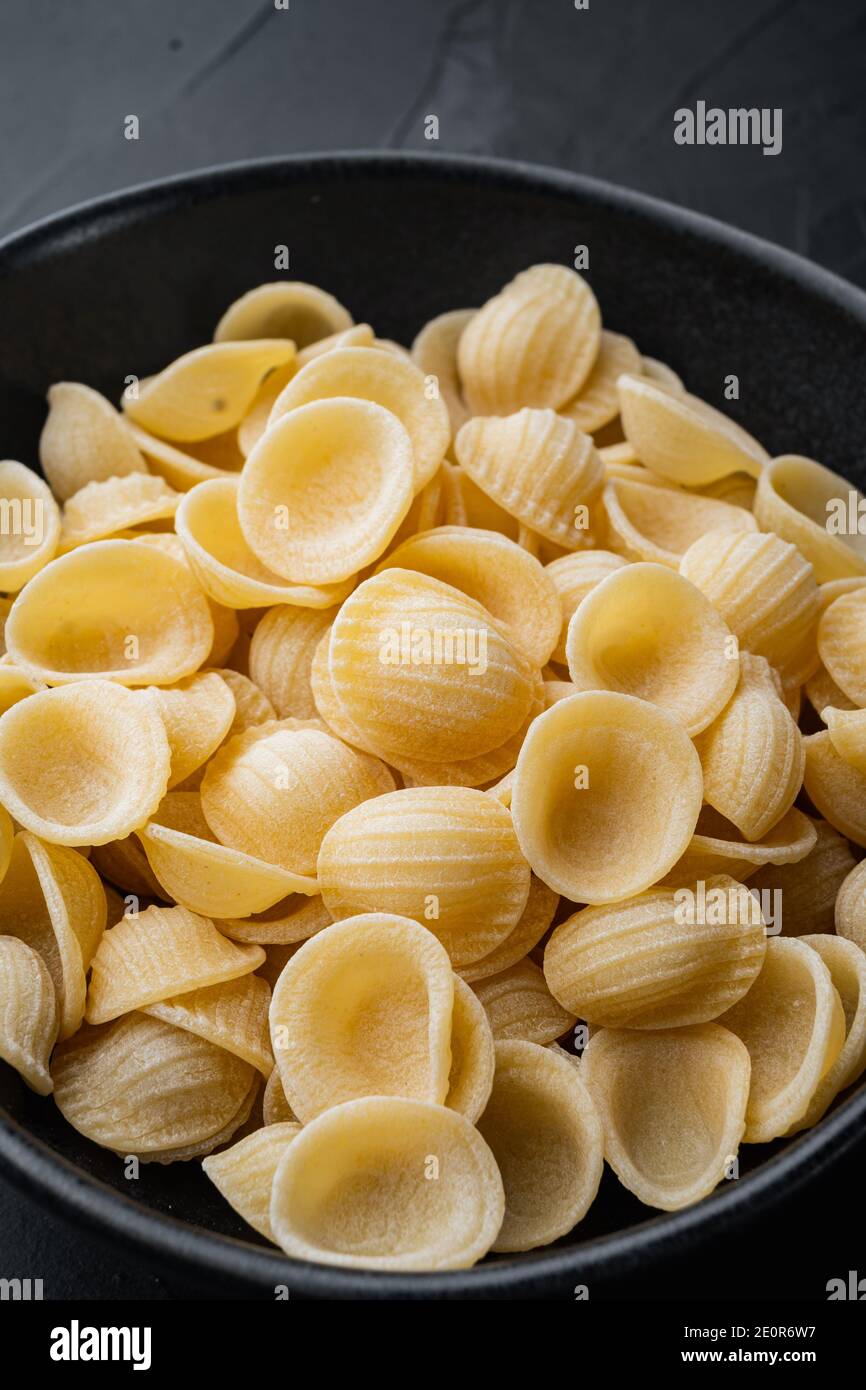 Durum wheat semolina pasta, on black background Stock Photo - Alamy