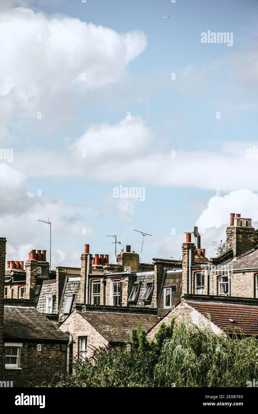 view of windows and typical London roofs over blue sky Stock Photo - Alamy