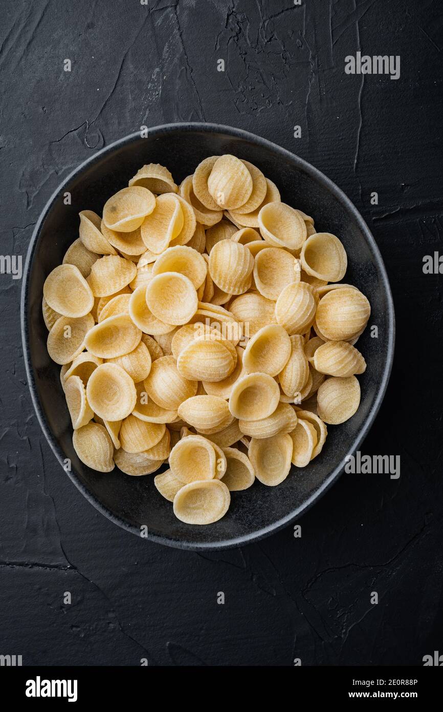 Dried pasta shells in bowl, on black background, flat lay Stock Photo ...