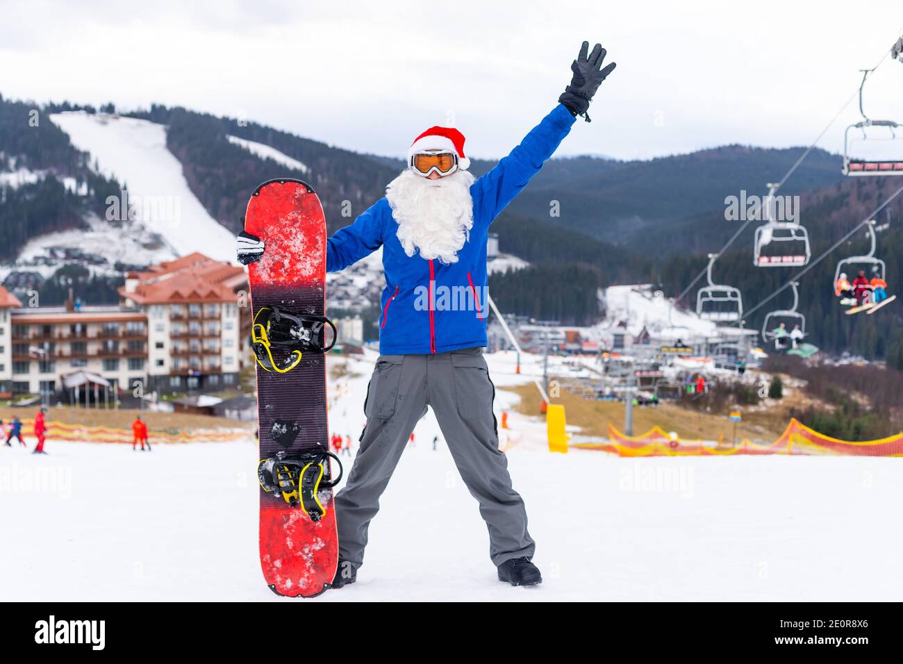 Serious santa claus in ski mask standing with snowboard Stock Photo - Alamy