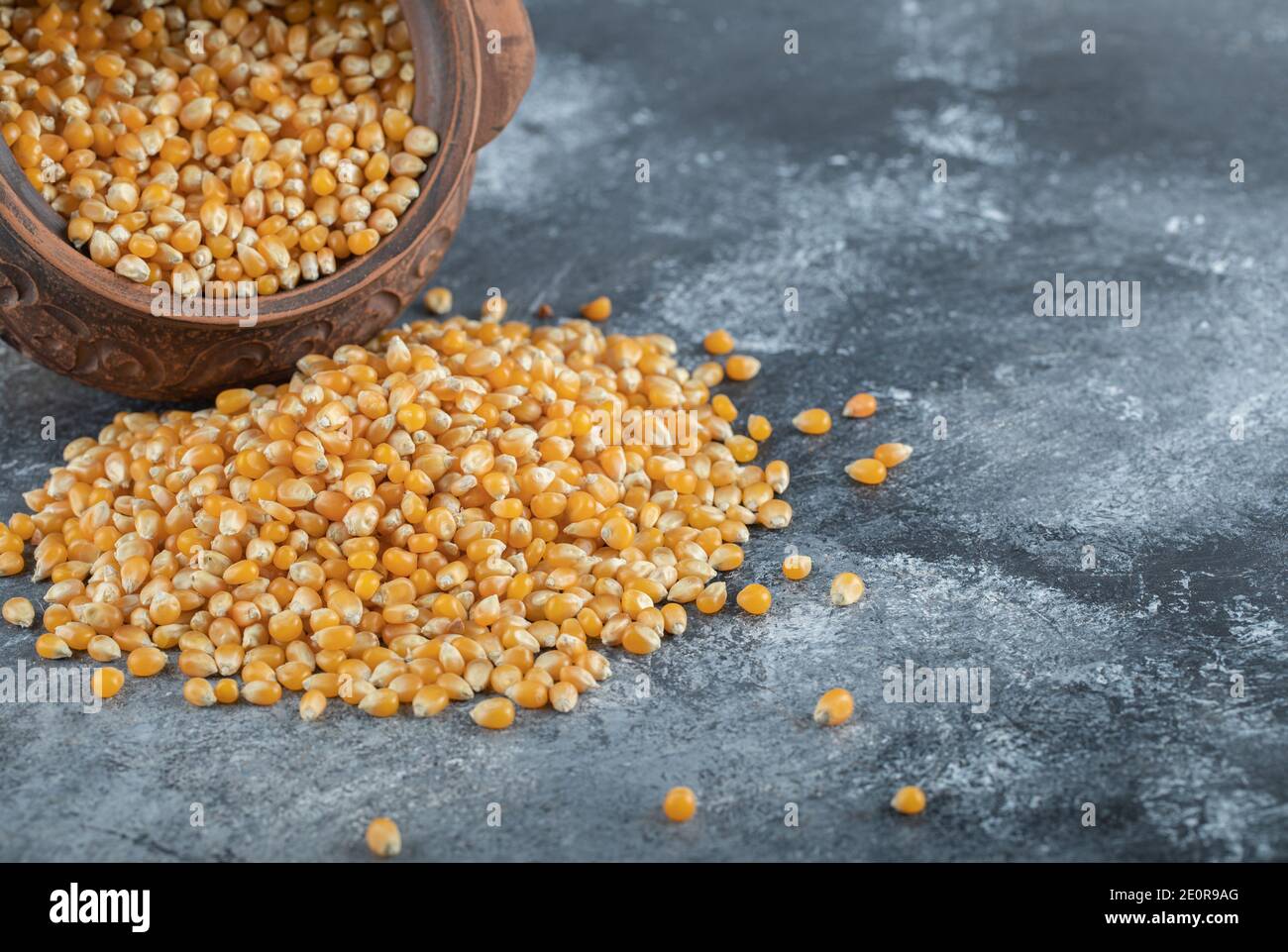 An ancient bowl full of uncooked popcorn seeds Stock Photo - Alamy