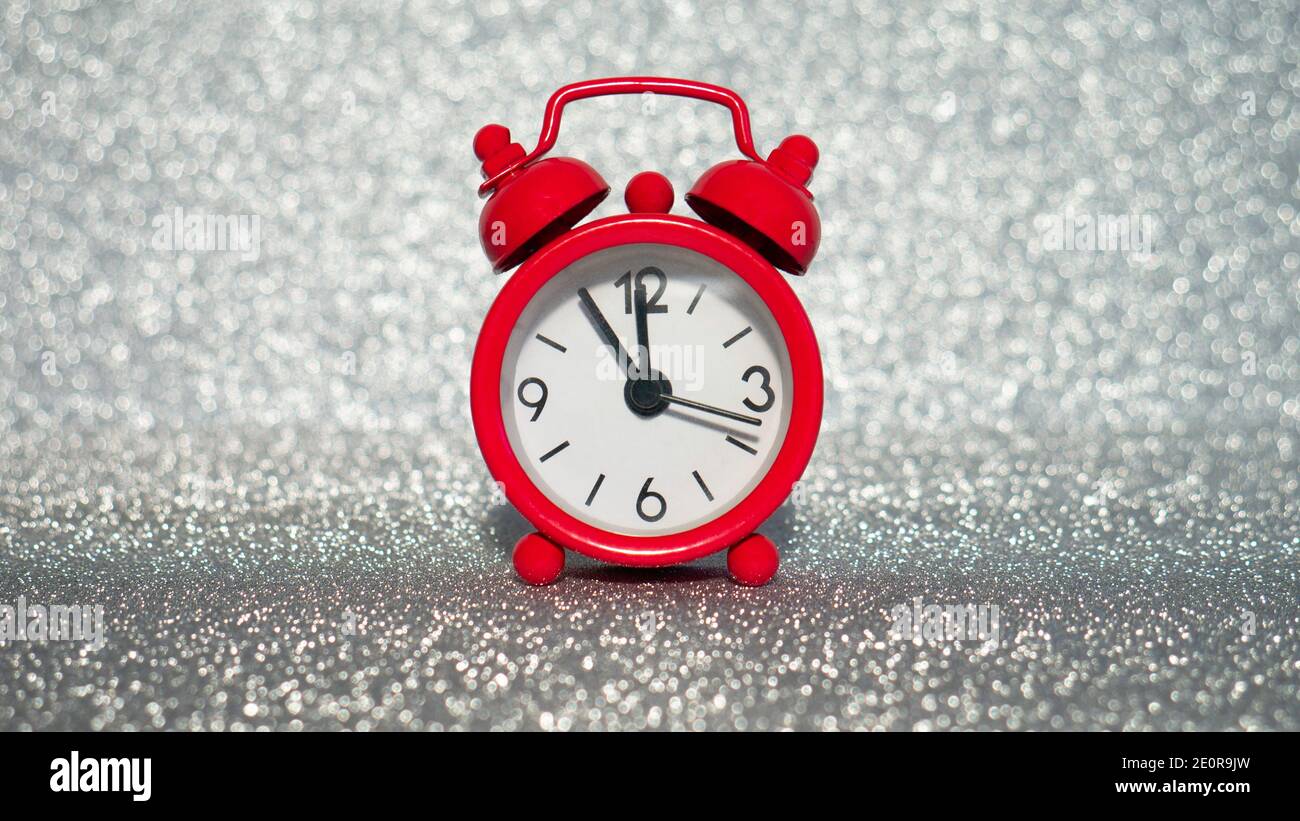 The red evening clock shows five minutes to midnight on a silver ...