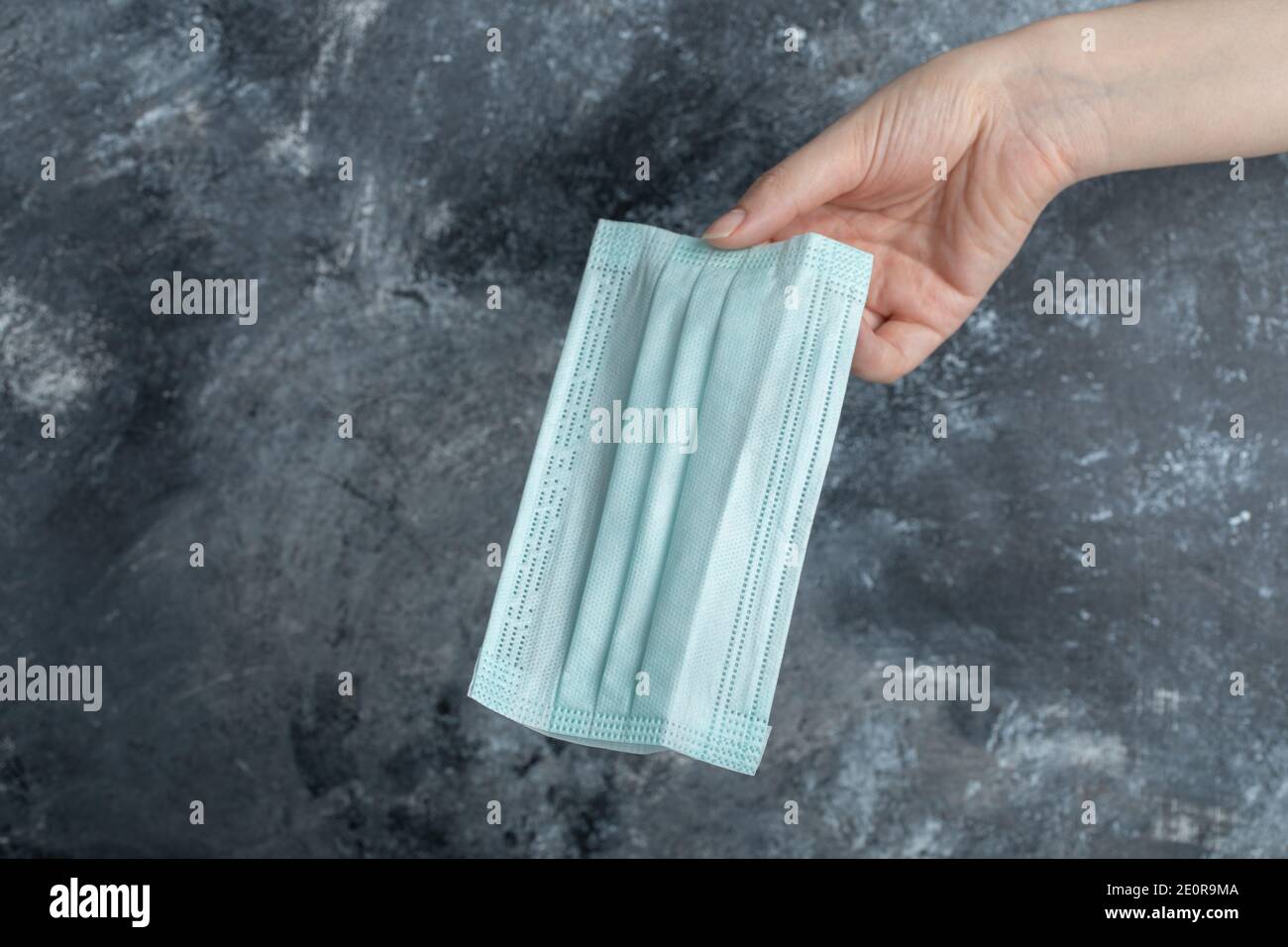 Female hand holding holding protection mask Stock Photo - Alamy