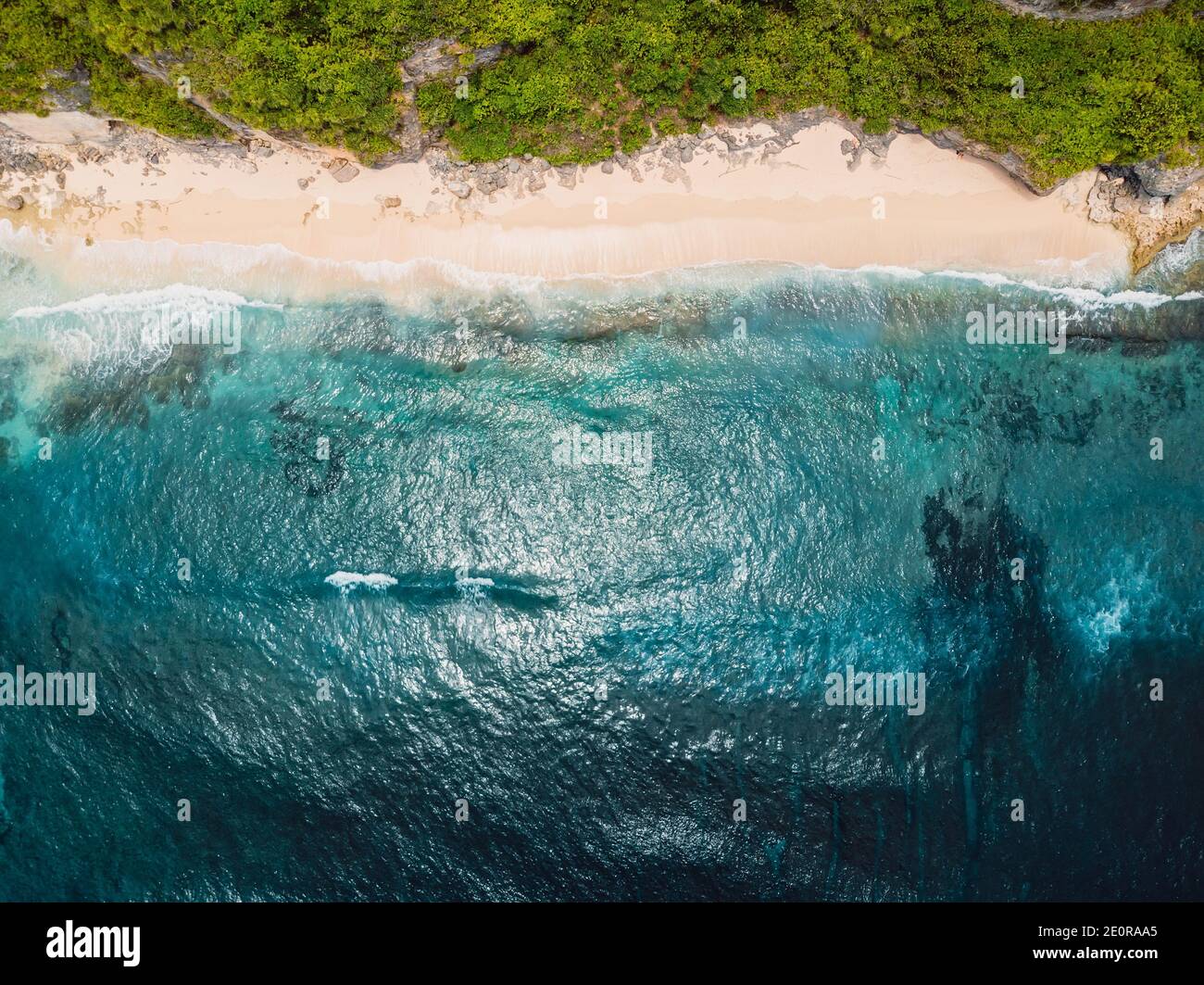 Wild tropical sandy beach and ocean with waves at Bali. Aerial view ...