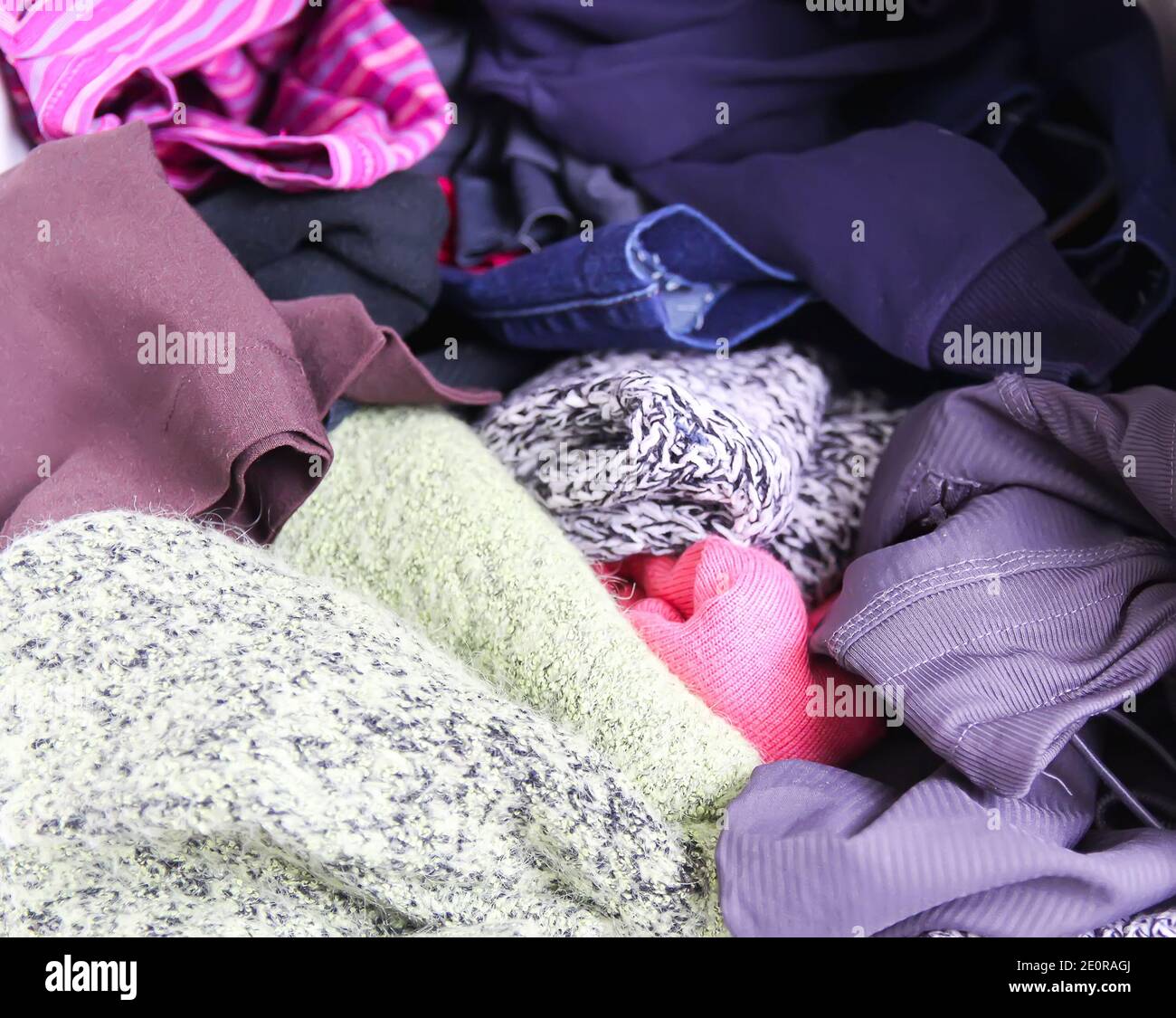 Home wardrobe with different clothes. Small space organization. The ...