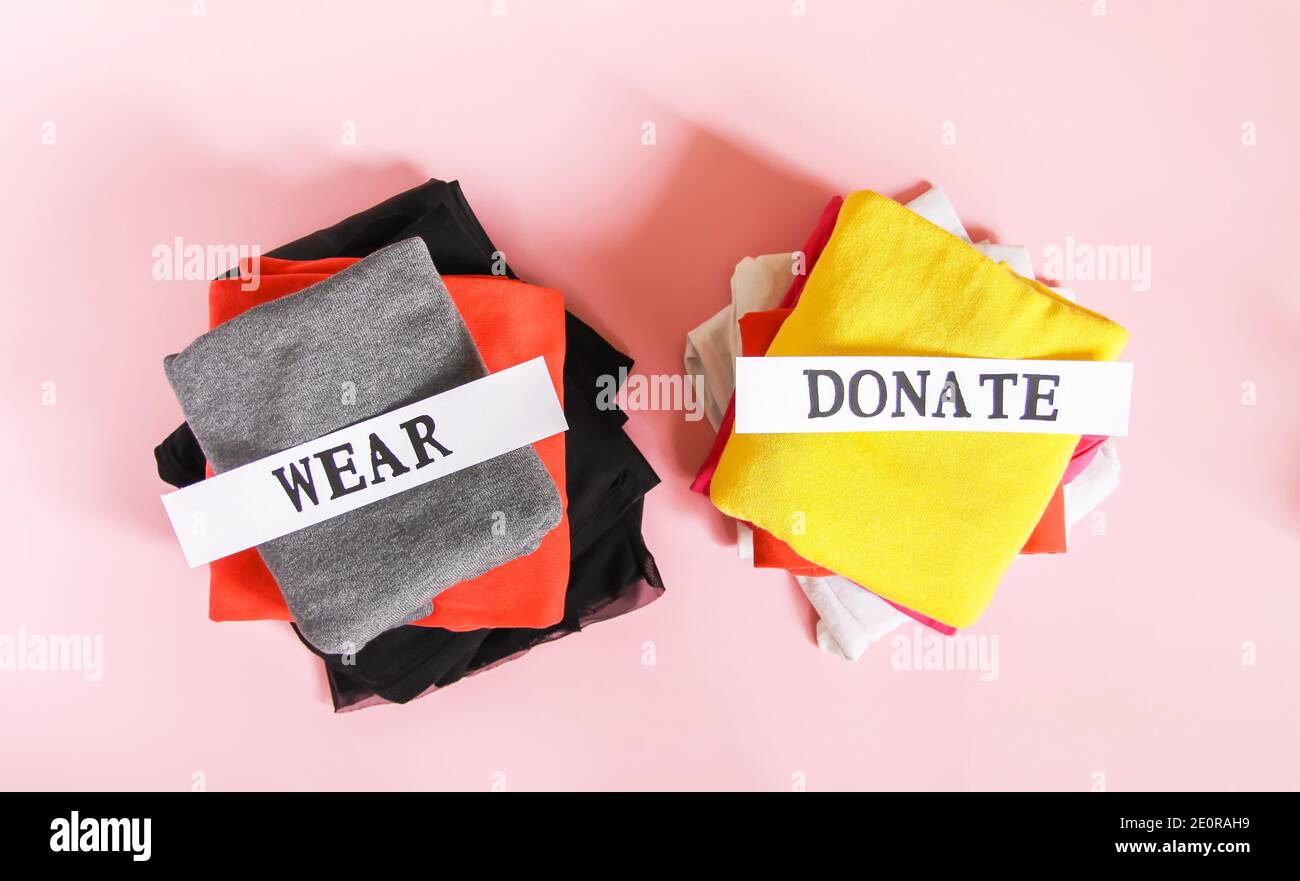 Clothes sorting in home wardrobe for donation and wearing with paper ...