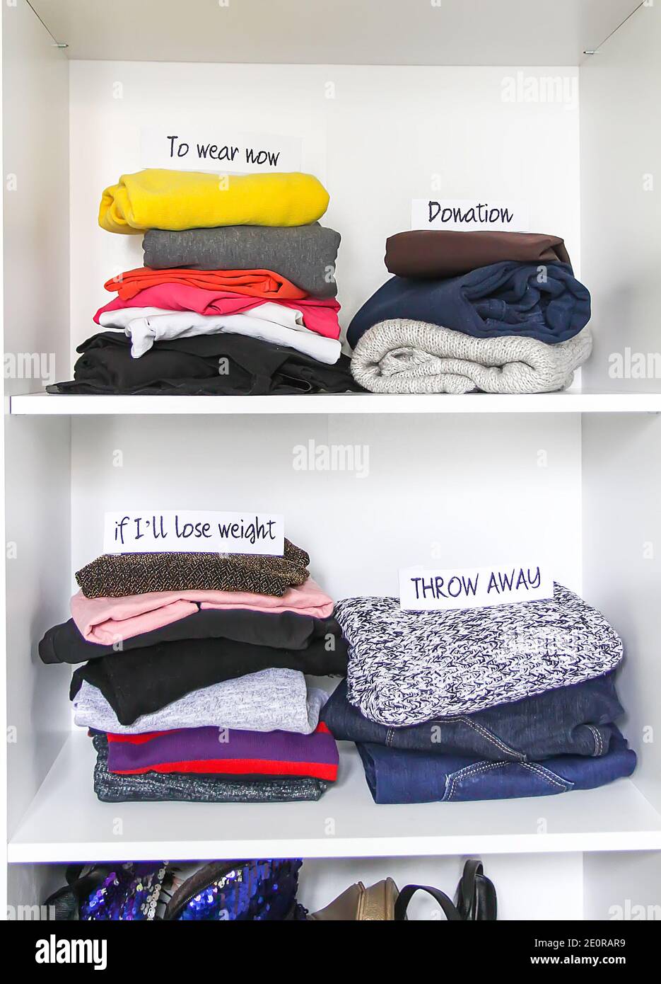 Different clothes in home wardrobe with paper notes. Small space ...