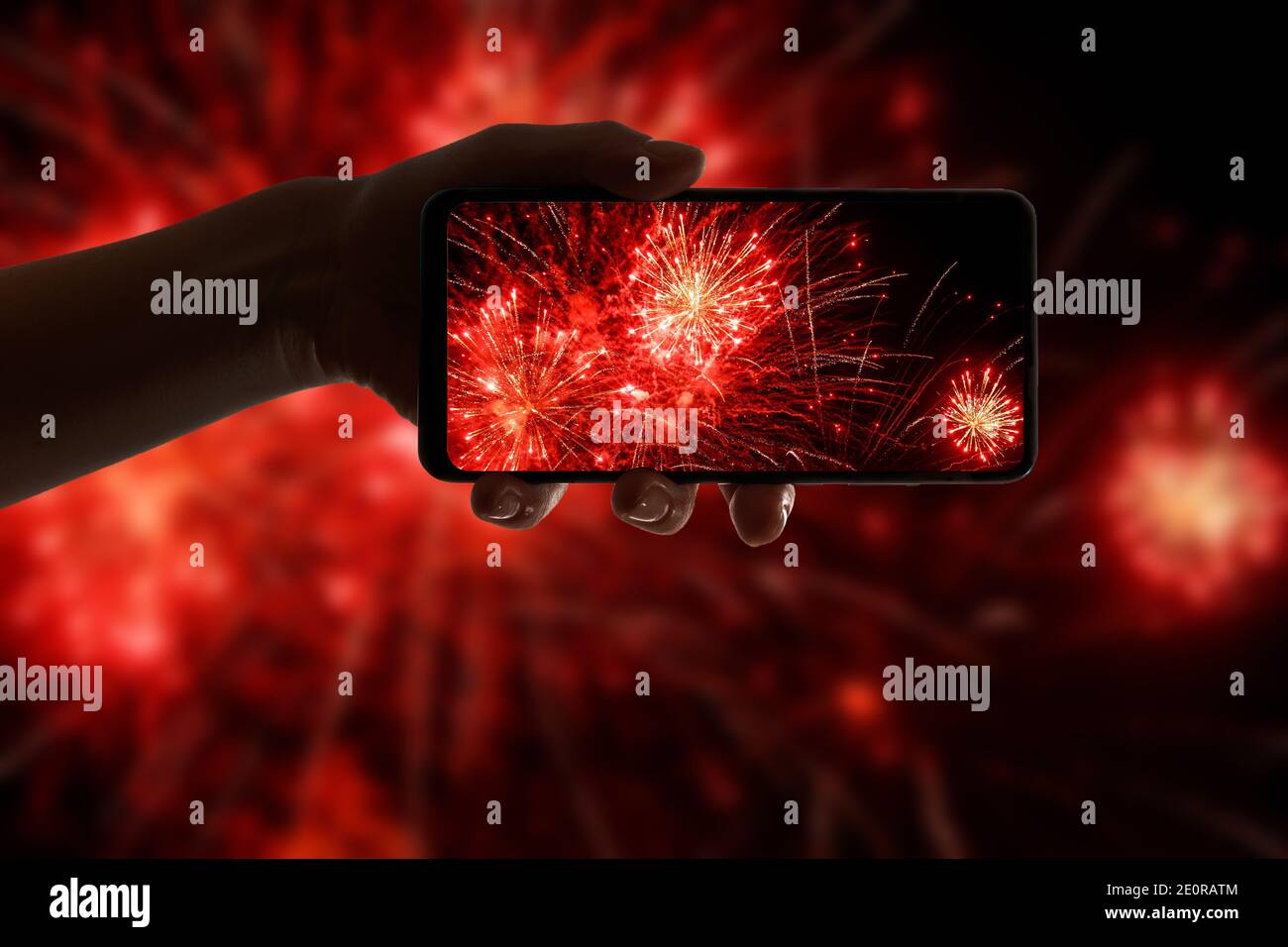 Taking the photo of fireworks via smartphone. Broadcast salute video to ...