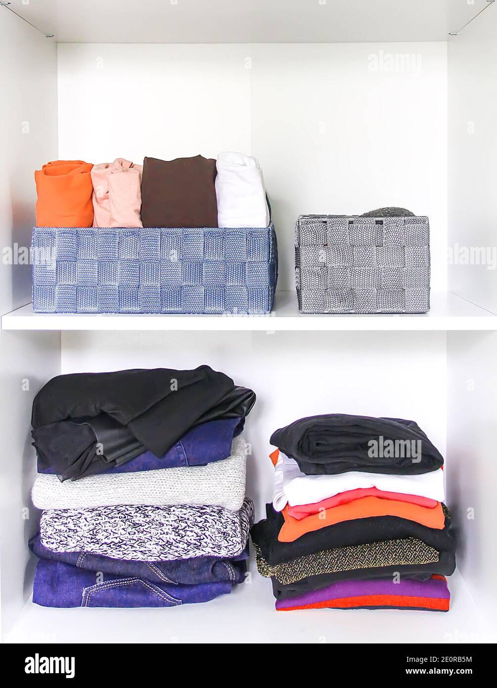 Different clothes in home wardrobe with paper notes. Small space ...