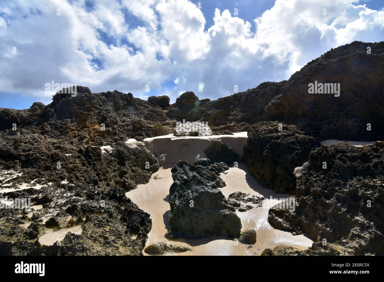 Rugged rough black lava rock landscape in Aruba Stock Photo - Alamy