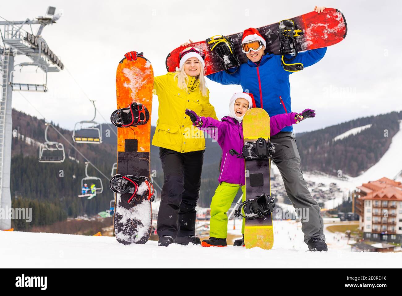 Winter time and skiing - family with ski and snowboard on ski ha Stock ...