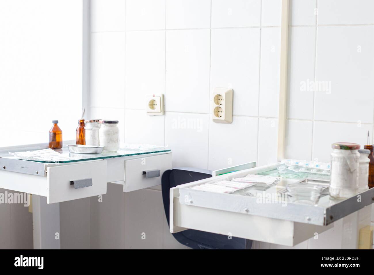 treatment room in the hospital, glass tables with medical instruments ...