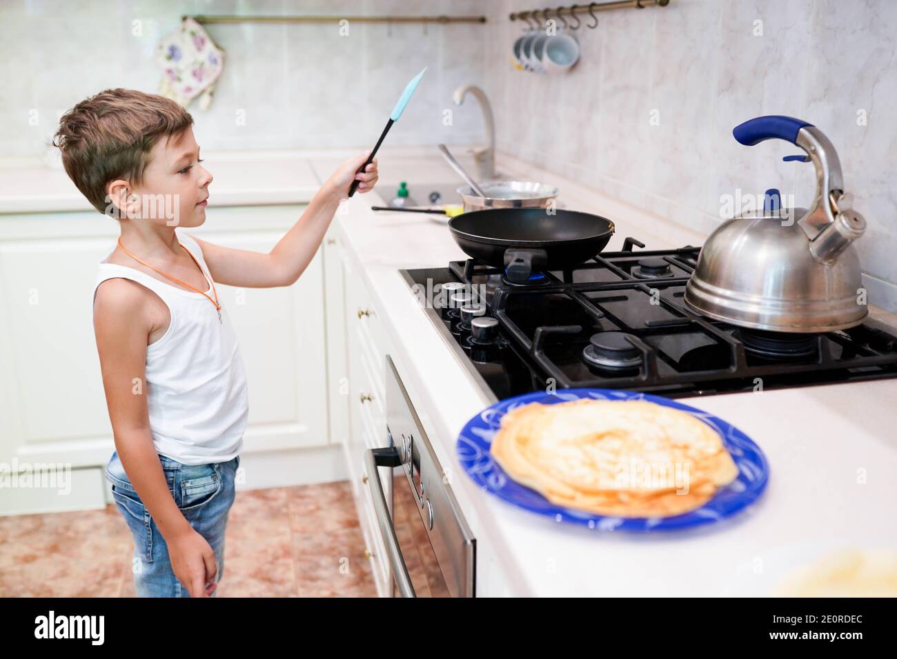 Boy cooking in the kitchen hi-res stock photography and images - Alamy