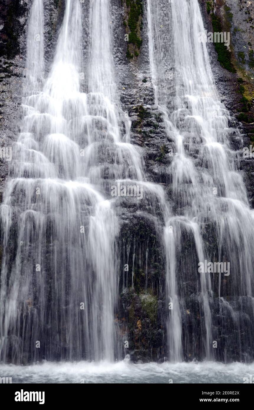 Vertical image of a waterfall in a river Stock Photo - Alamy