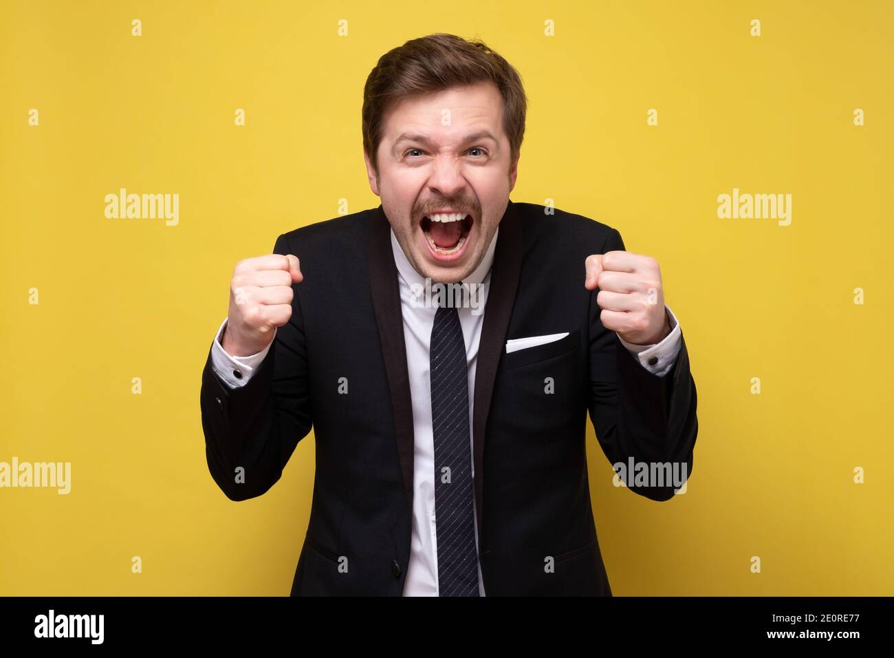 Excited businessman winning, arms up fists pumped celebrating success ...
