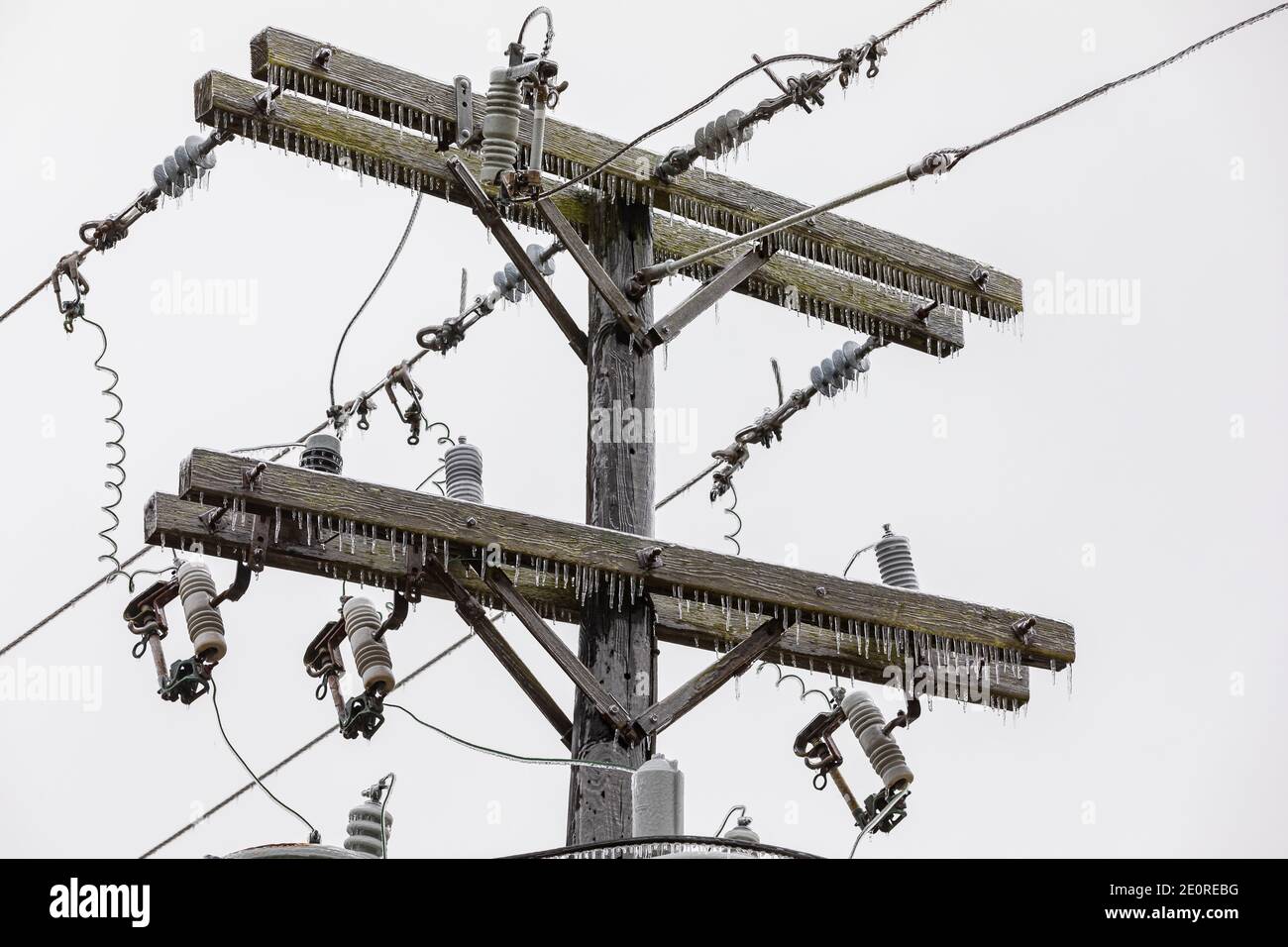 Ice on electrical utility pole and power line from freezing rain ...