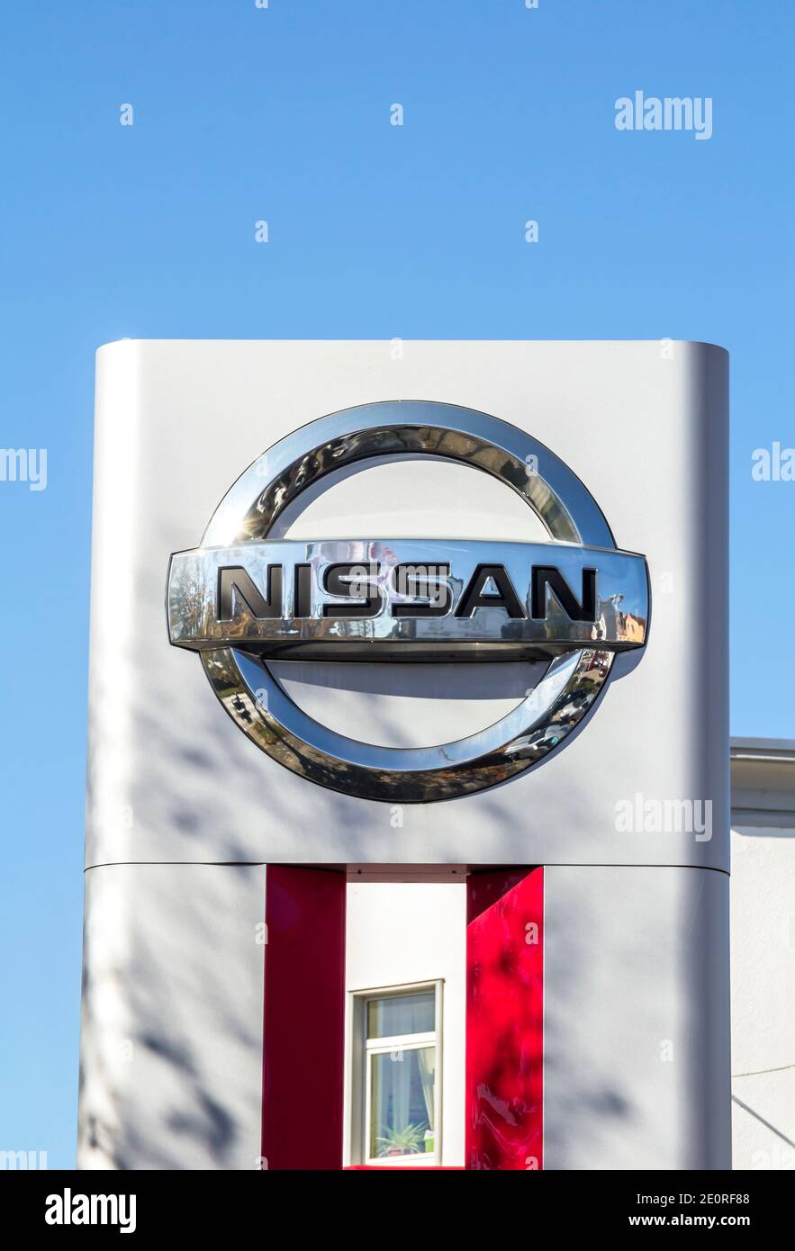 Nuremberg, GERMANY: Nissan dealership sign against blue sky. Nissan is ...