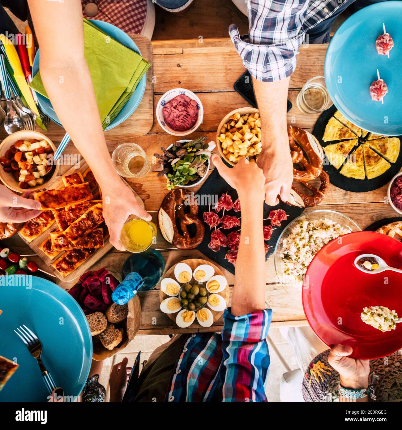 Vertical view of group of friends family eating together on a wooden ...