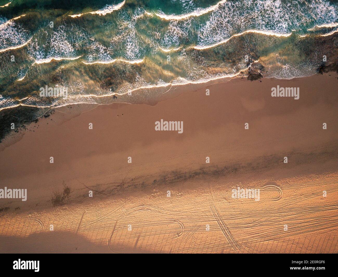 Aerial view of sand beach and blue transparent sea water with waves ...