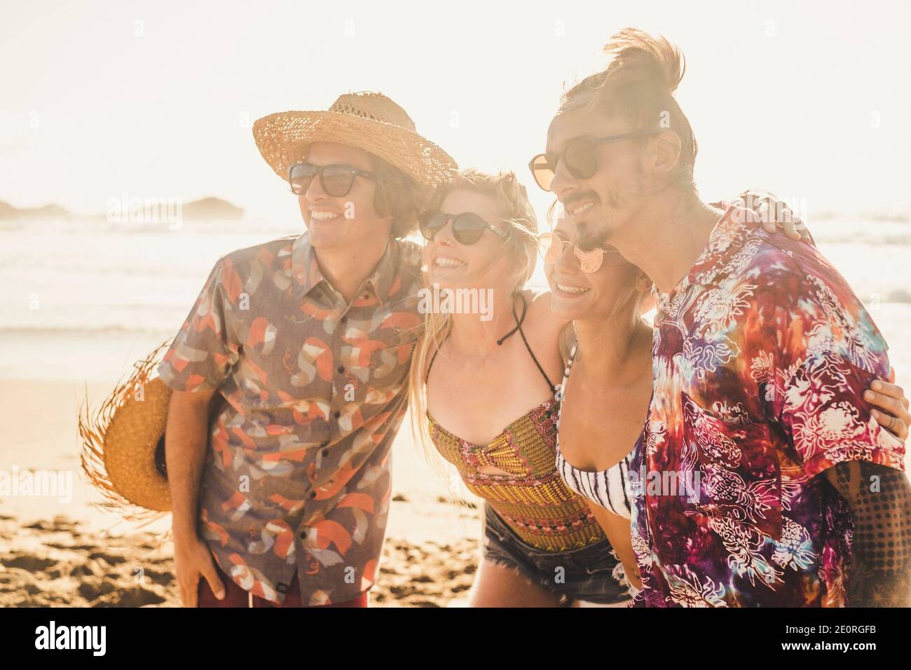 Group of couples friends have fun together at the beach in summer ...