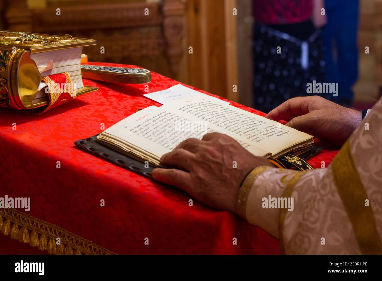 A priest holding the Bible at a christian ritual. Christian celebraton ...