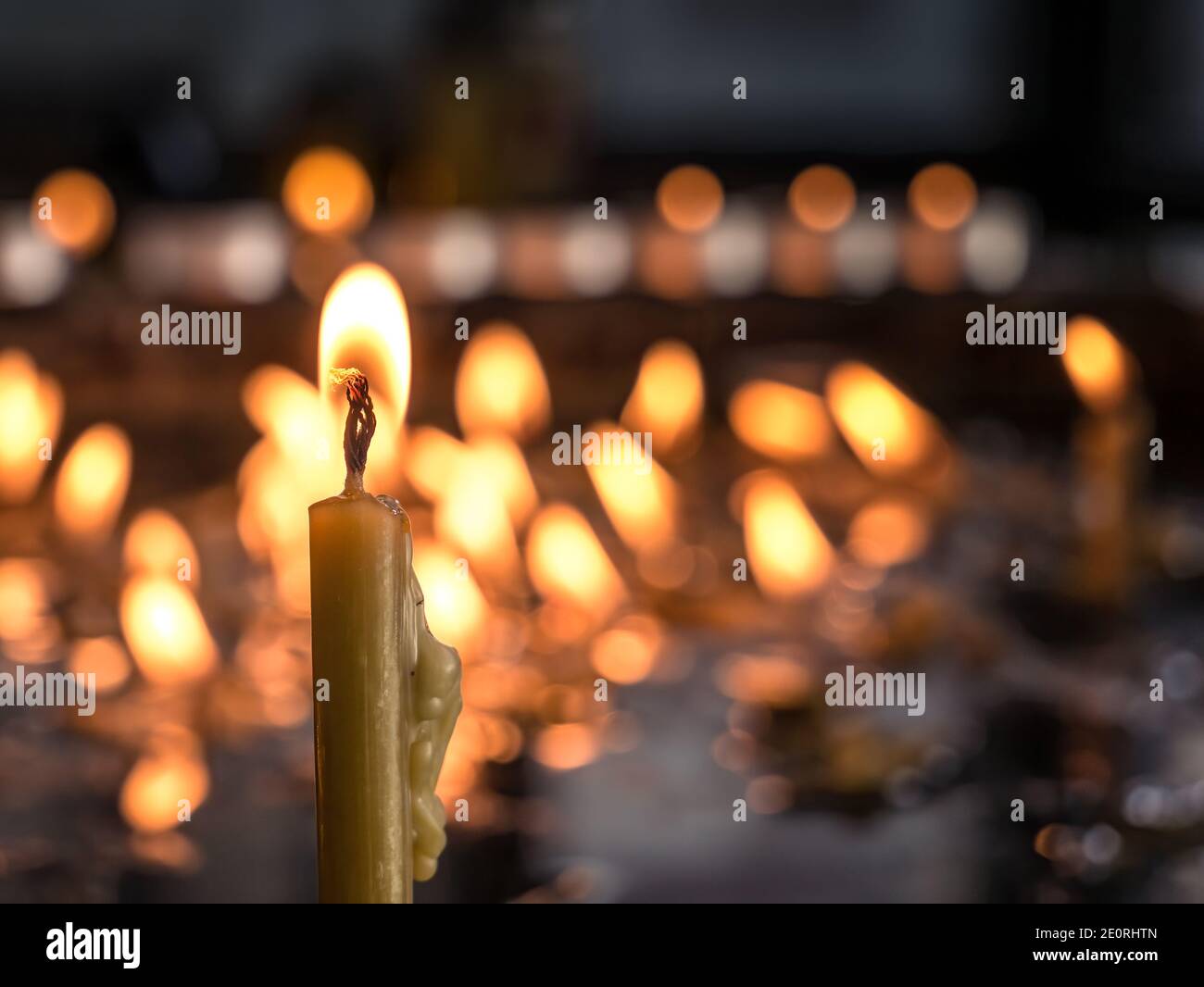 Burning candles in memory of the dead. Melted wax from candles Stock ...