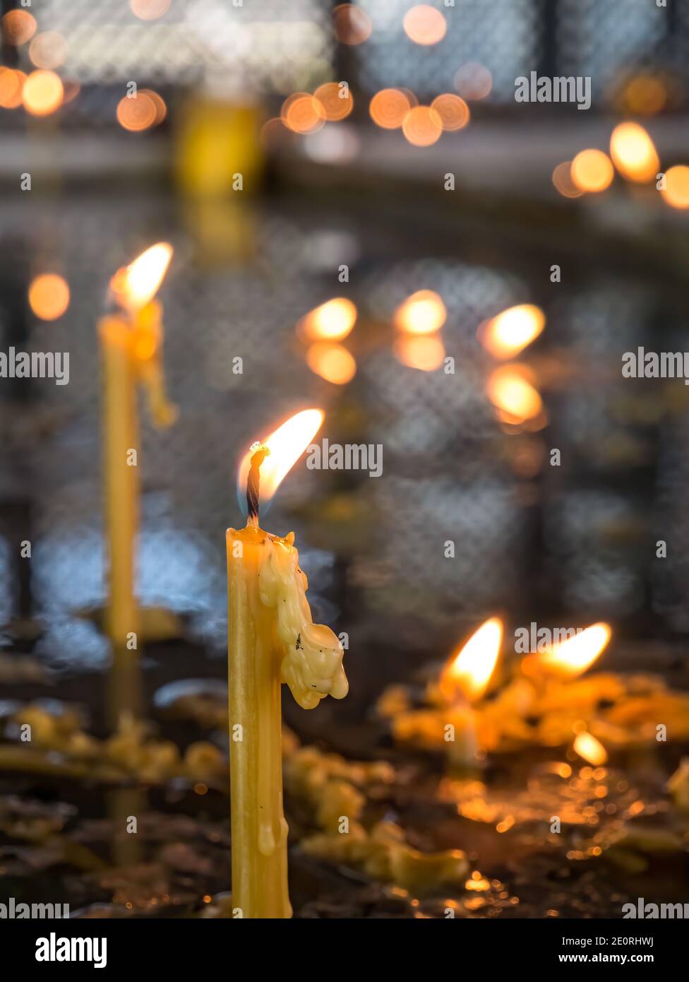 Burning candles in memory of the dead. Melted wax from candles Stock ...