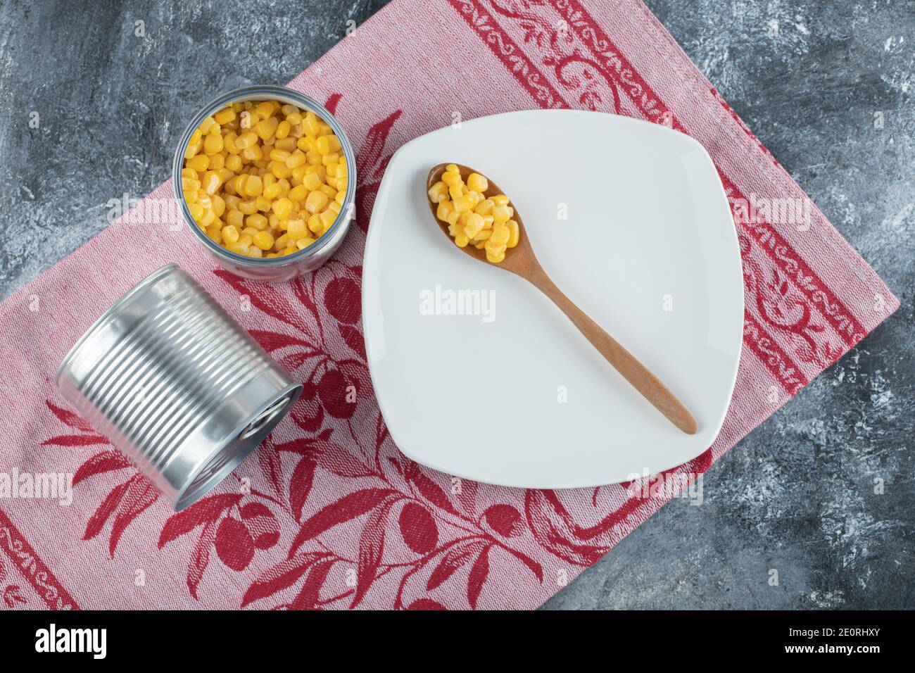 A wooden spoon of popcorn seeds on an empty plate Stock Photo - Alamy