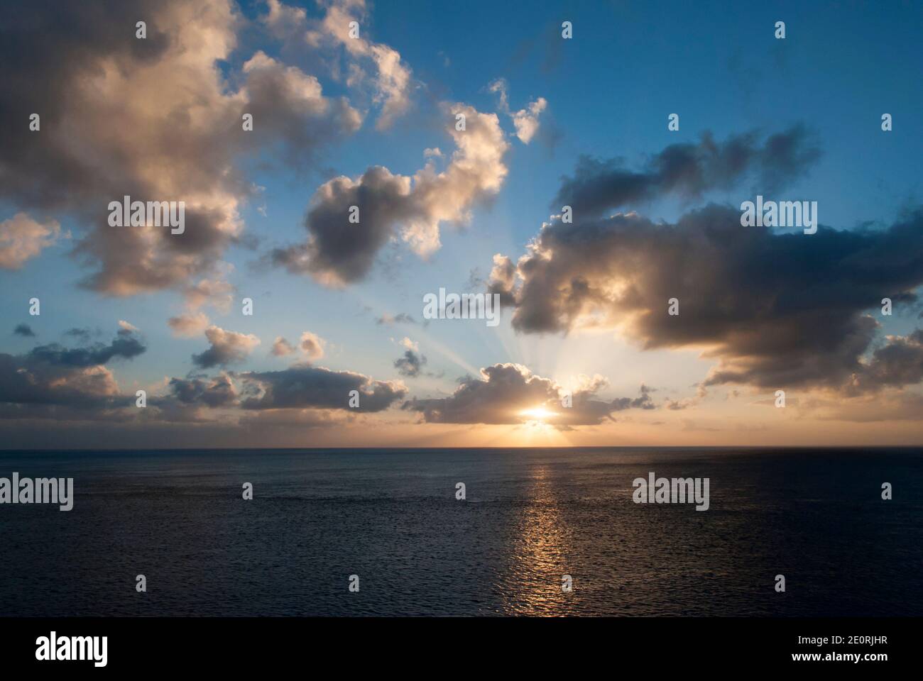 The sunset view with orange clouds and a sunlight path as seen from ...