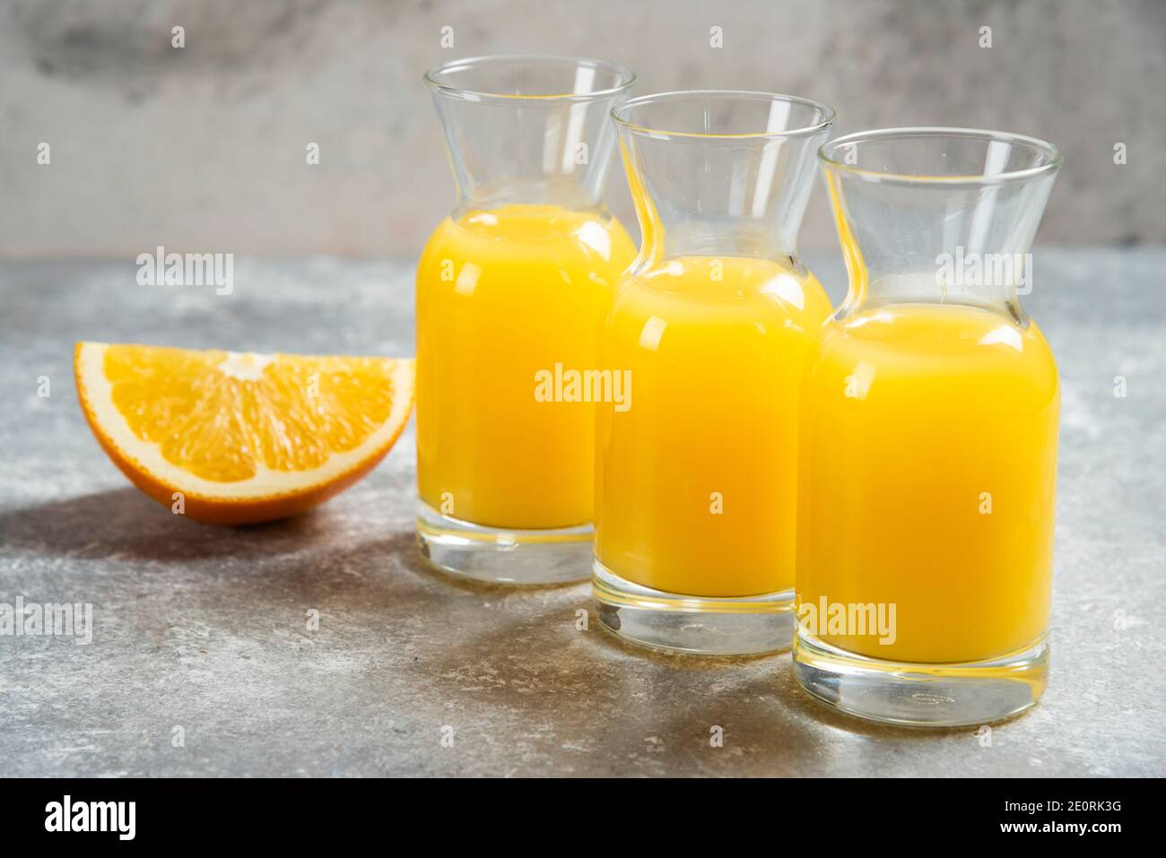 Glass jars of orange juice and slice of orange Stock Photo - Alamy