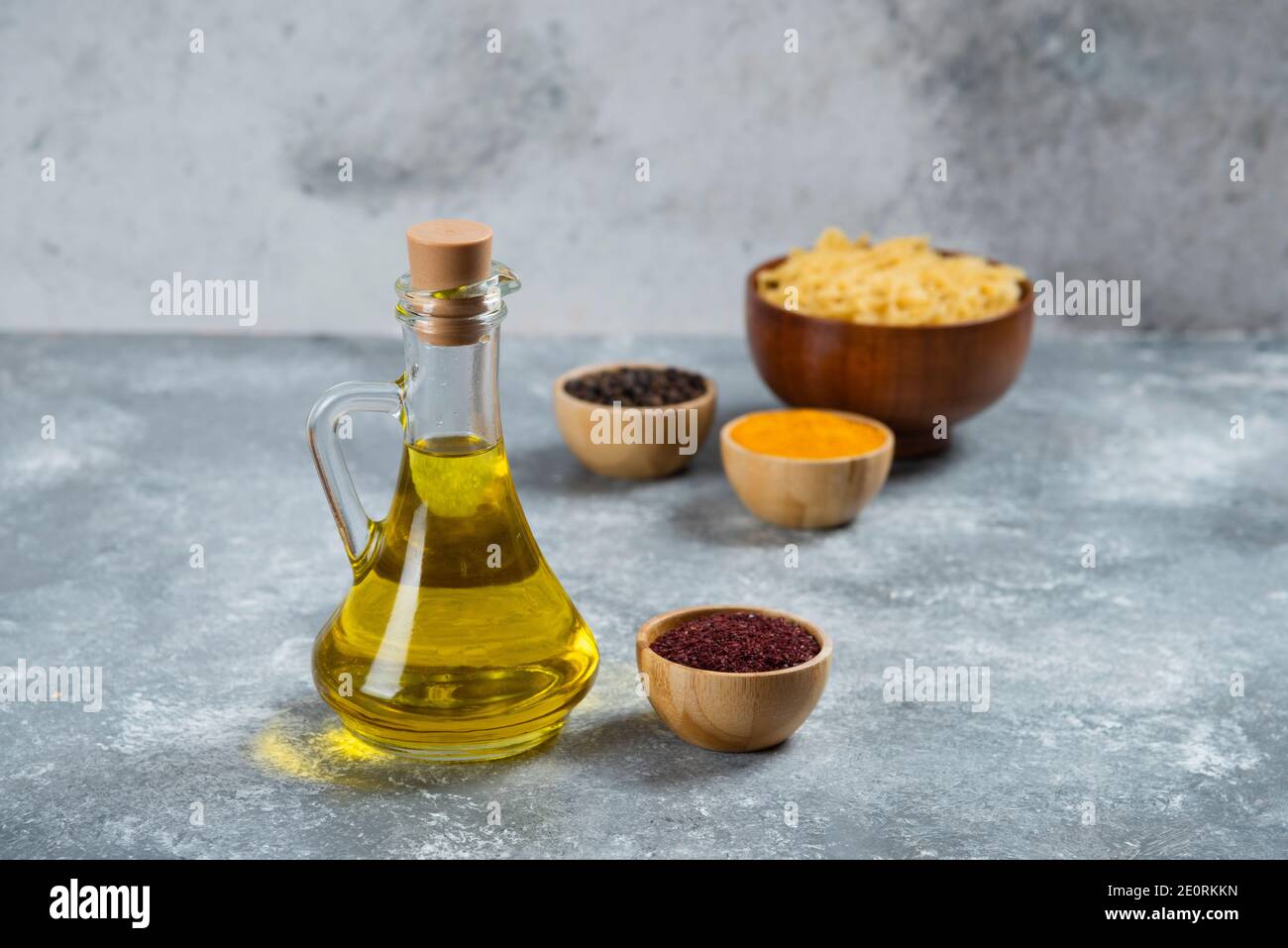 A glass bottle of oil with raw macaroni Stock Photo - Alamy